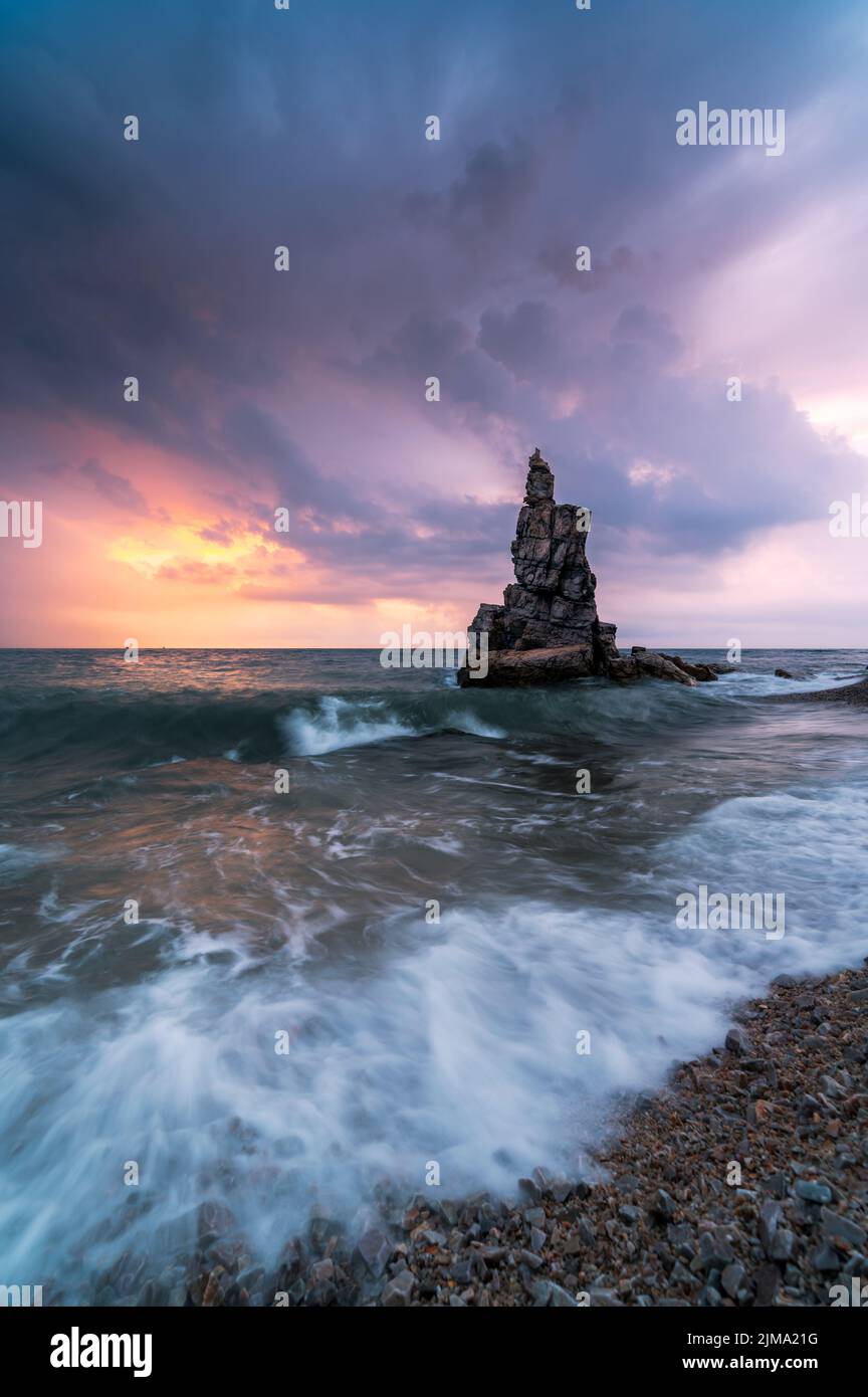 Magnificent seascape of colorful sunset, steep waves crashing on the ...