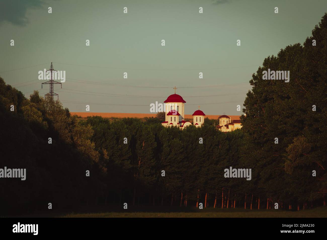 A white church with red dome with forest in the foreground Stock Photo ...