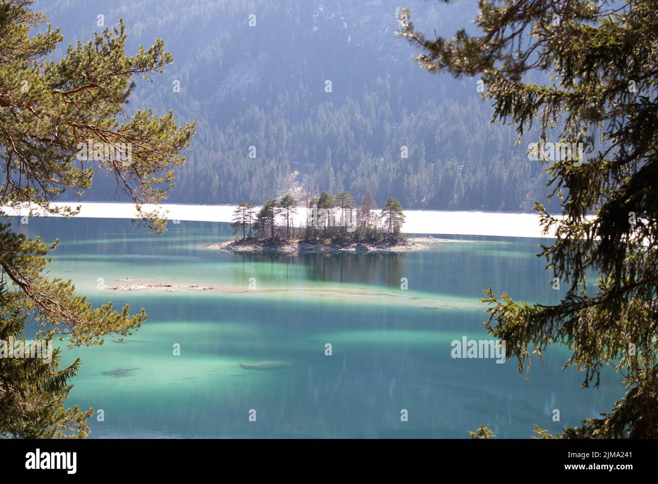 Lake Eibsee with turquoise color and small island near Wetterstein in ...