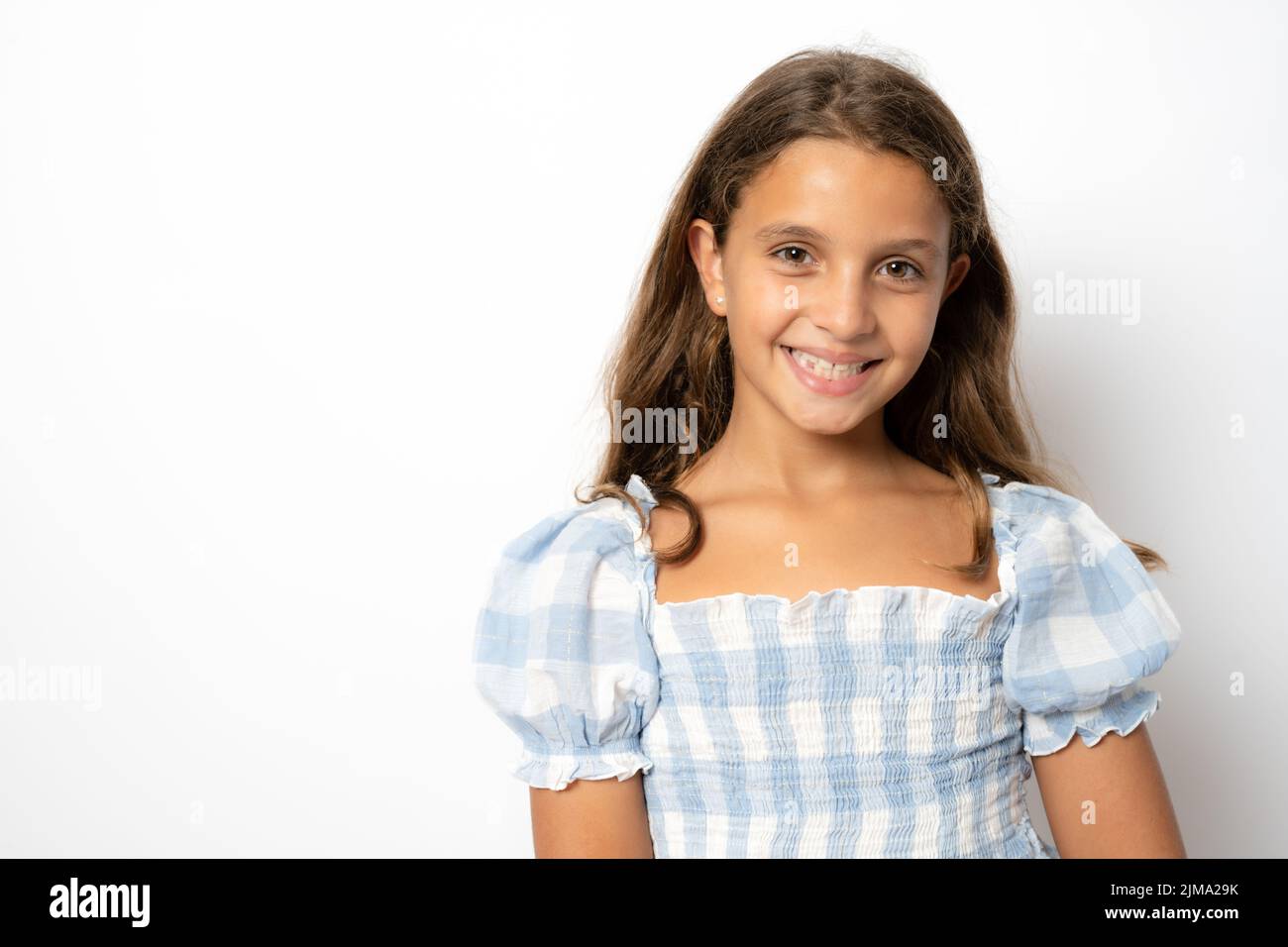 Close up portrait of cute smiling kid girl standing isolated over white ...