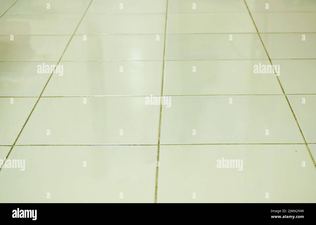 wet tile floor danger for slip in home Stock Photo - Alamy