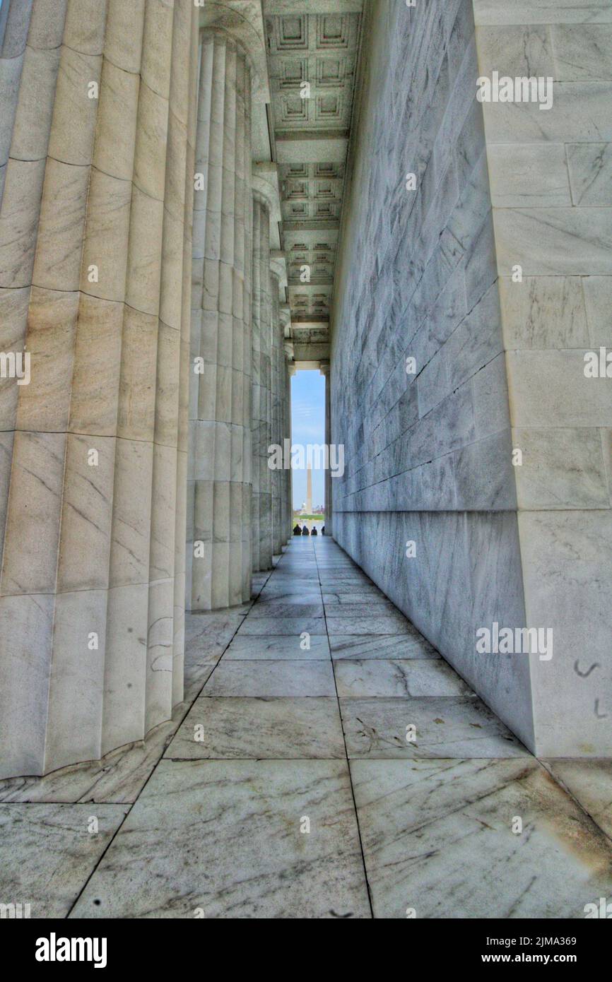 The vertical view of a hallway in the marble built building exterior ...
