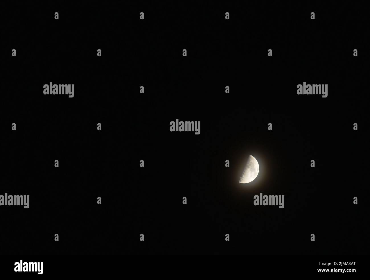 half moon spreading light on clear sky in night Stock Photo - Alamy