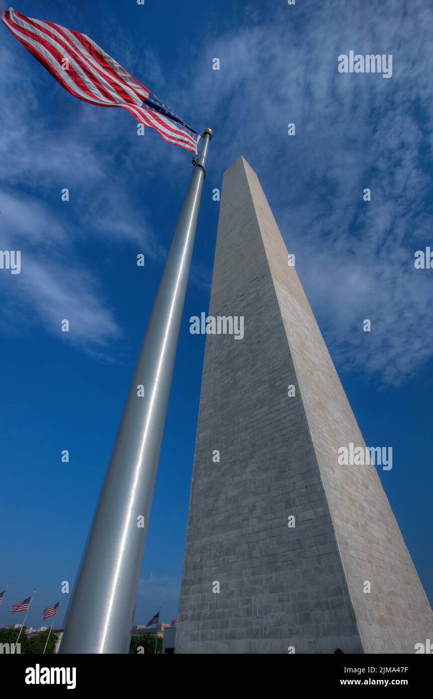 US Flag stretching into the sky next to the Washington Monument Stock ...