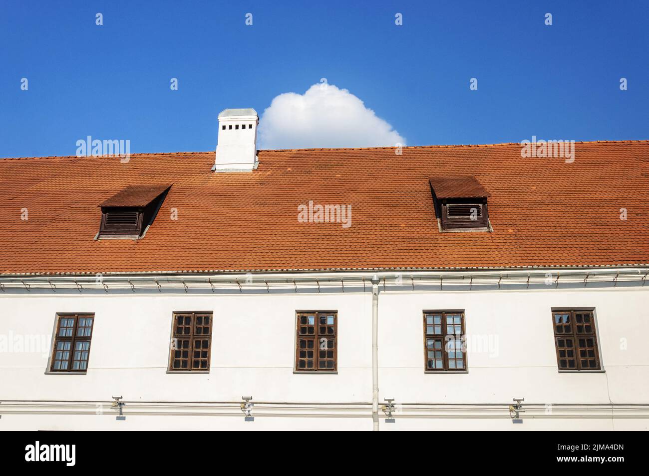 Old tiled roof with two attic windows and chimney Stock Photo - Alamy
