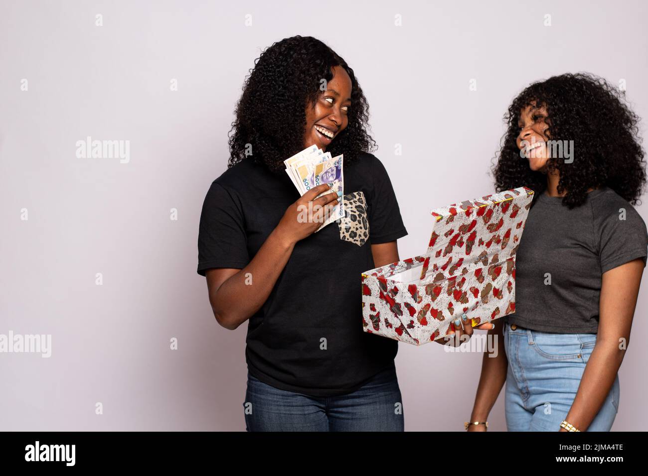 African holding money box hi-res stock photography and images - Alamy