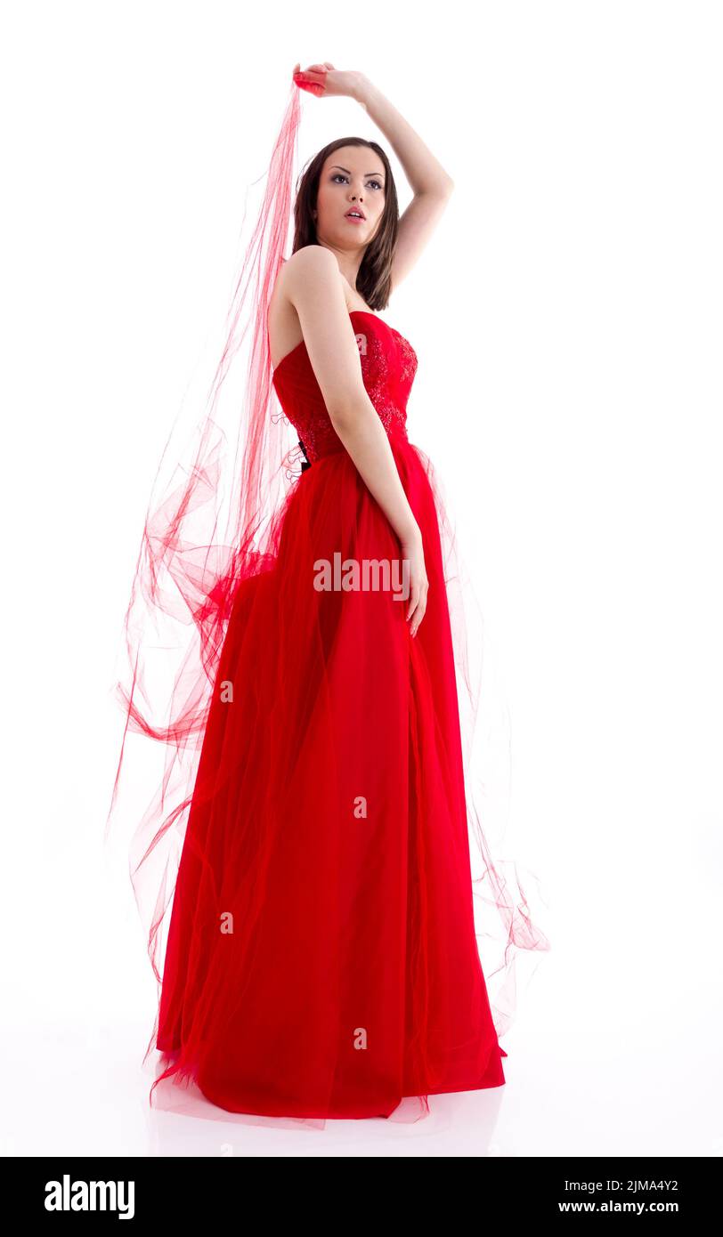 Beautiful woman in a red dress posing for a photo shoot Stock Photo - Alamy