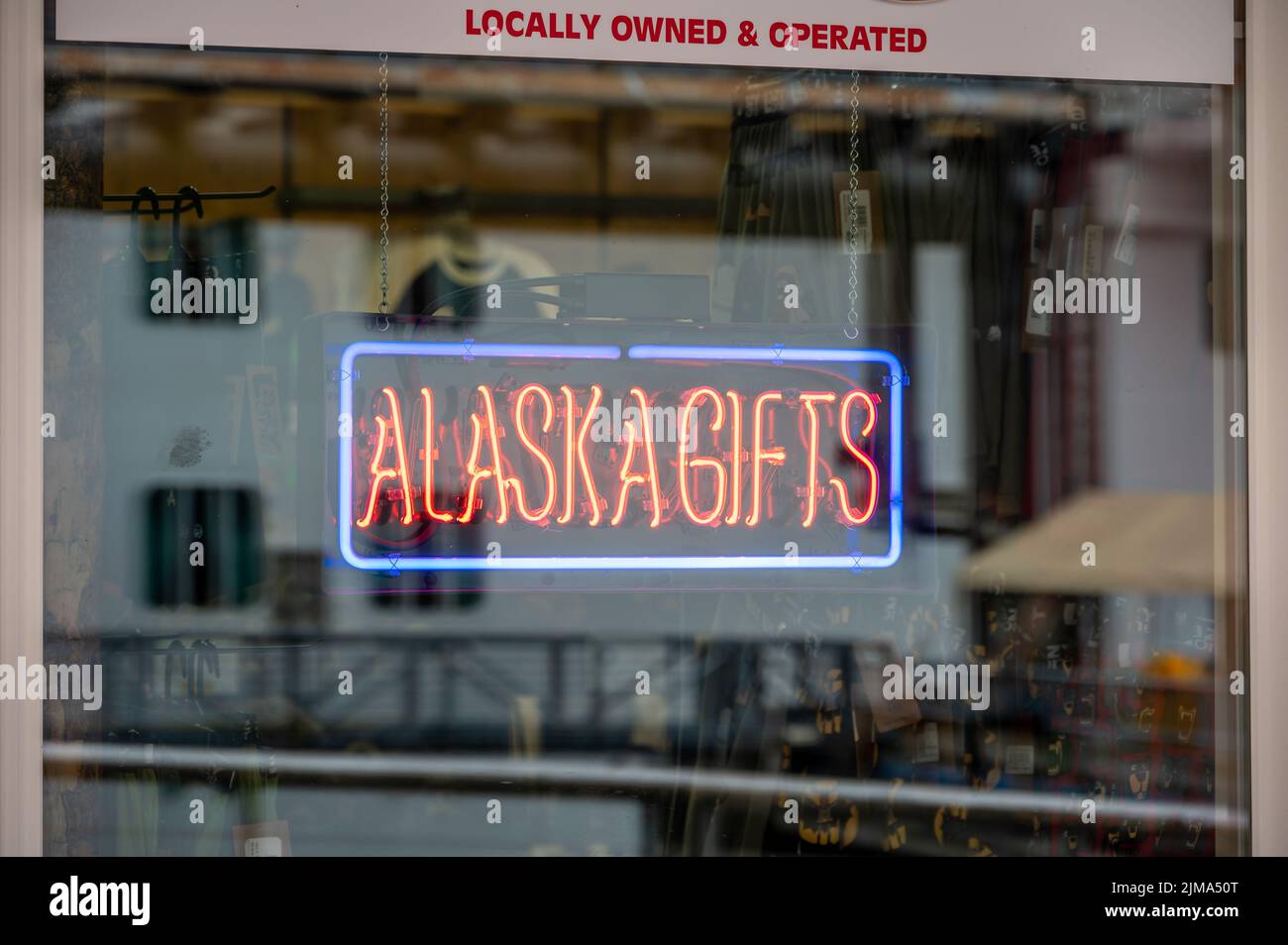 Neon alaska gifts sign in a window in Juneau, Alaska Stock Photo - Alamy