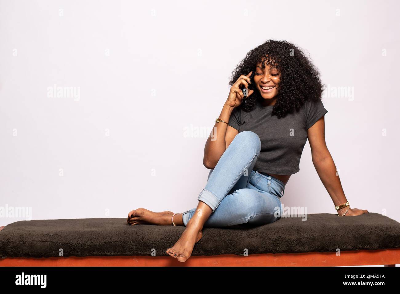 happy beautiful young black lady making a phone call Stock Photo - Alamy
