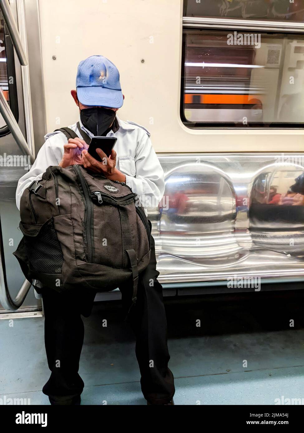 An old man sitting in the subway Stock Photo - Alamy