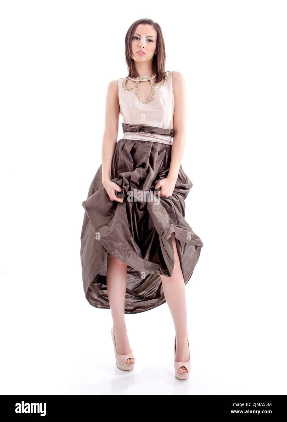 Beautiful woman model posing in elegant dress in the studio Stock Photo ...