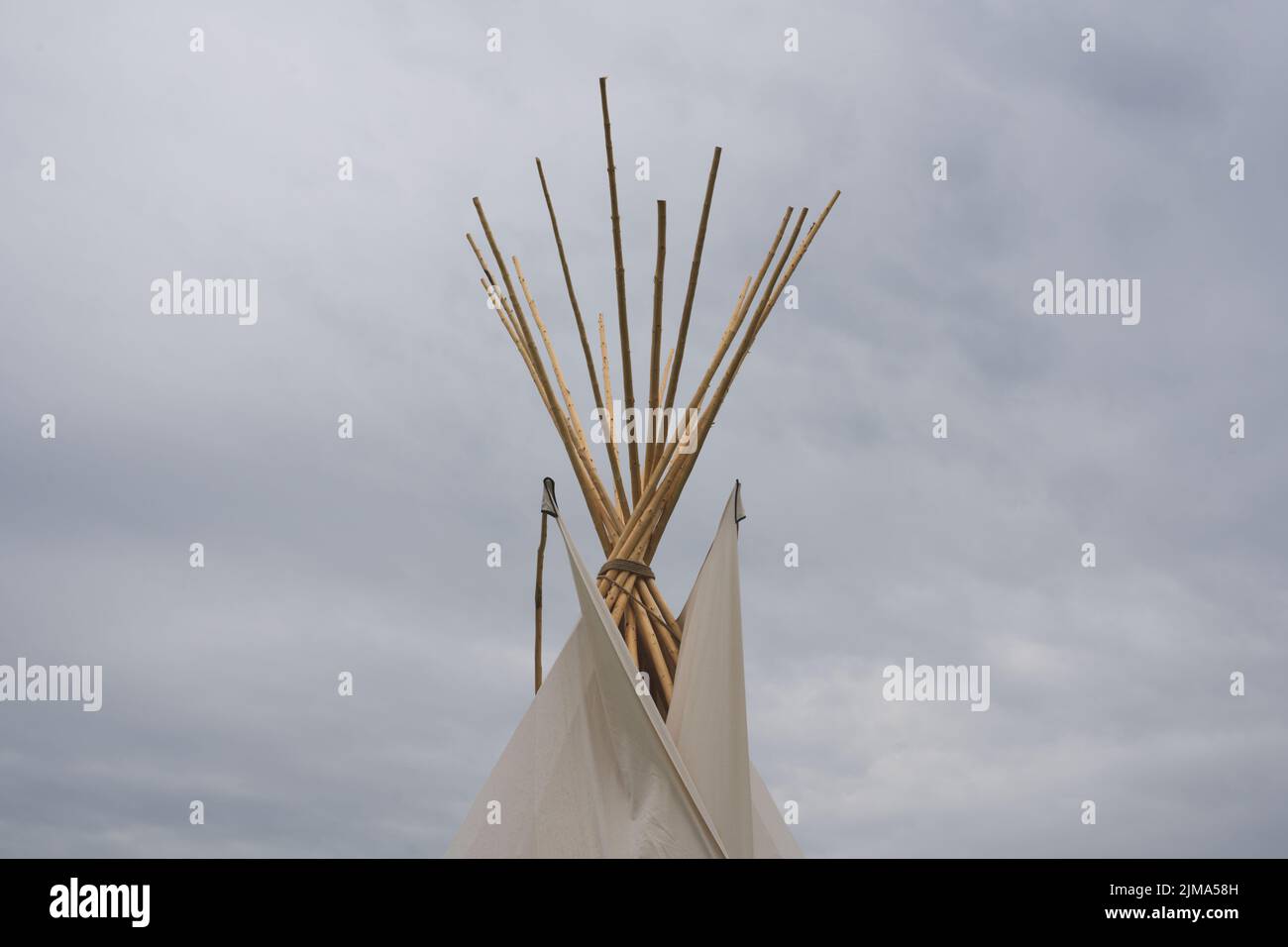 A view of the upper part of the Native Teepee on the sky background ...