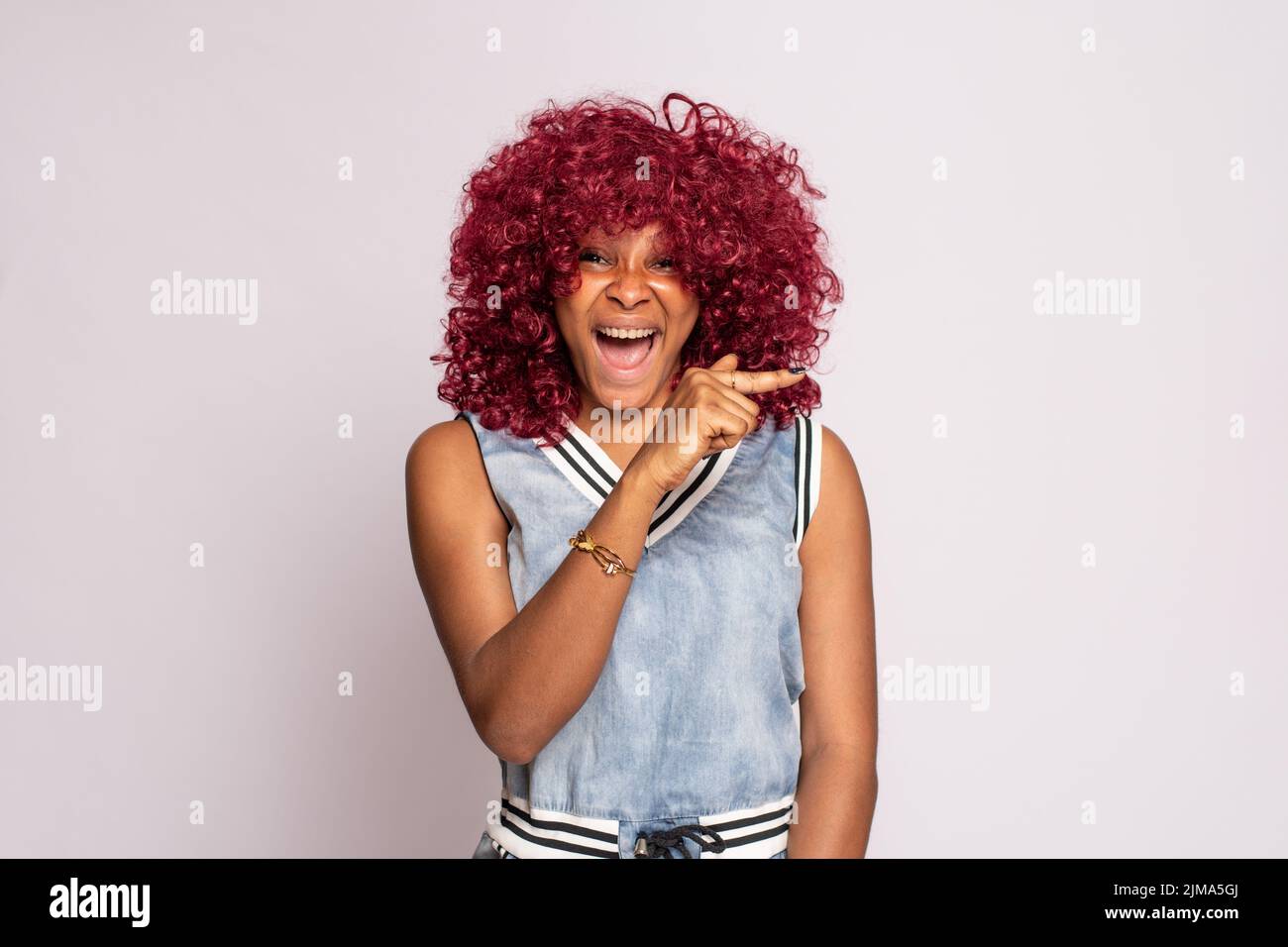 excited black girl points to her side, advertising concept Stock Photo ...
