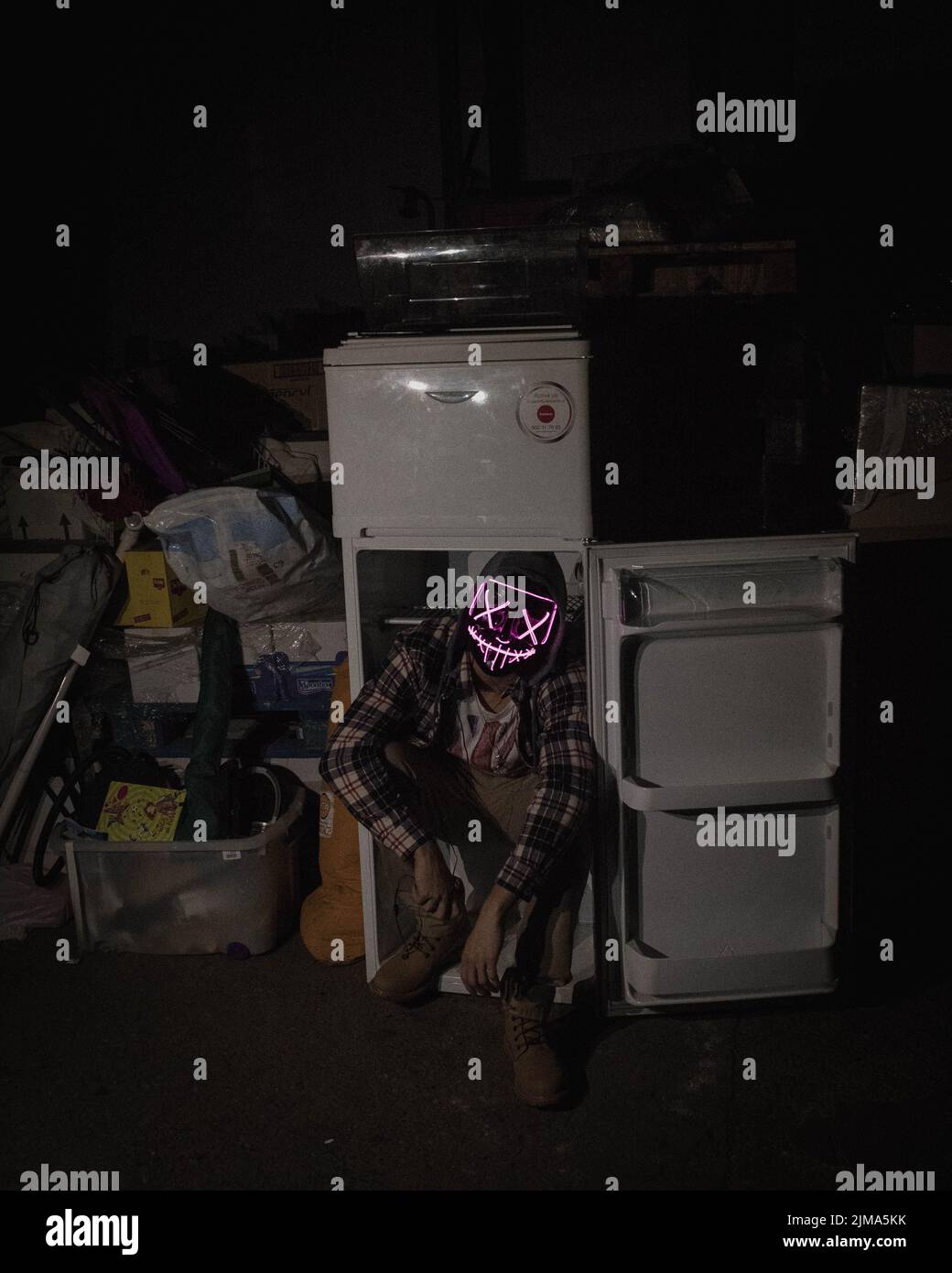 A Young boy in a fridge wearing led glow purge mask Stock Photo - Alamy