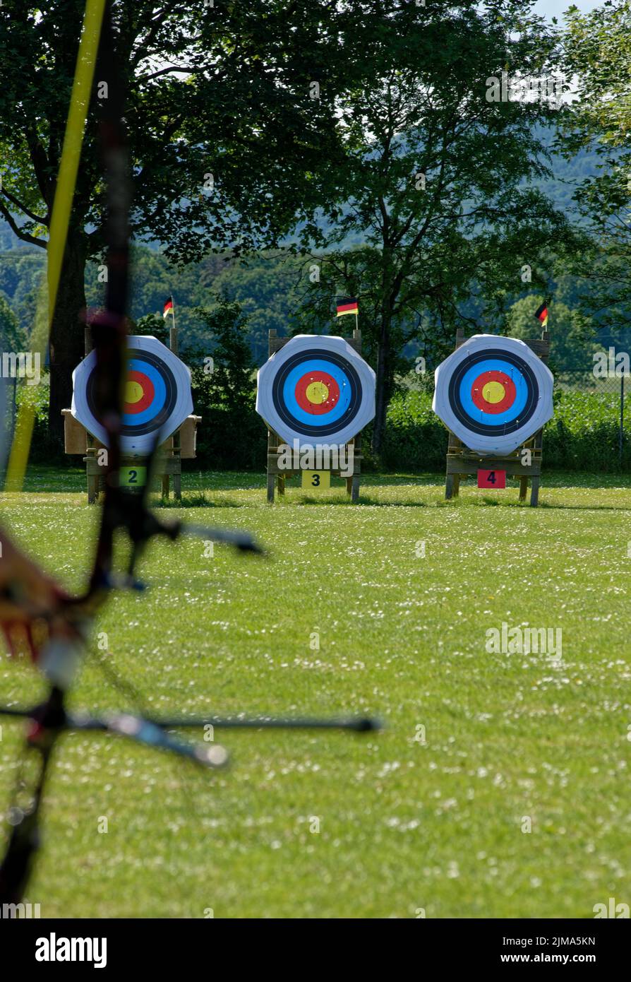Archery targets with colorful taget faces on green grass during an ...