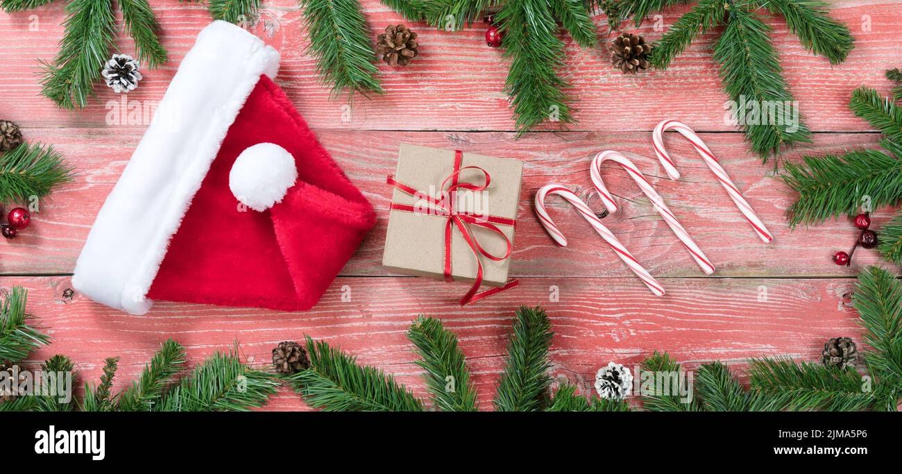 Rustic red wooden boards with border of fir branches and other ...