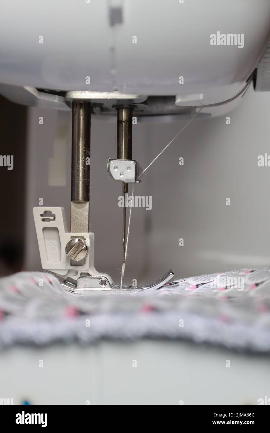 a sewing machine foot with needle and sewing tray with a cotton and ...