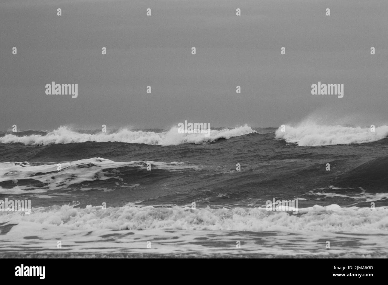 A scenic grayscale shot of sea waves washing the shore Stock Photo - Alamy