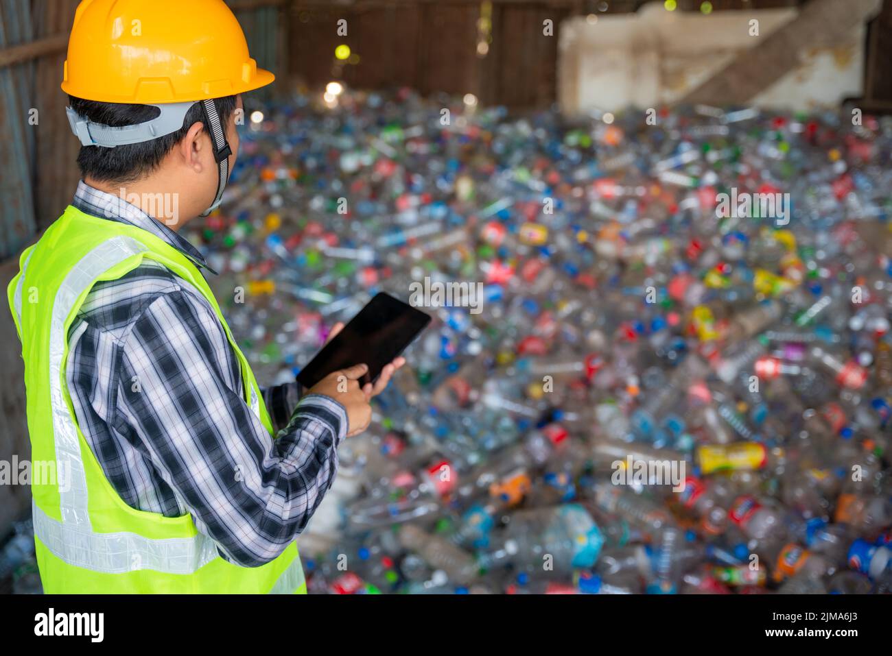A workers work on recycle waste, Recycling Analyst looking at recycling ...