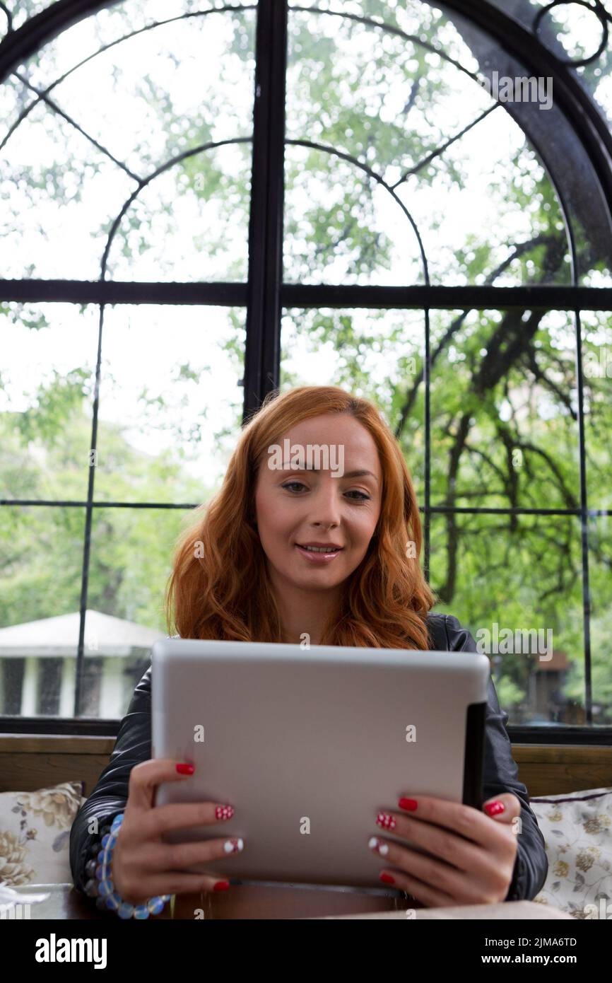 Pretty girl posing with a tablet in cafe, beautiful girl Stock Photo ...