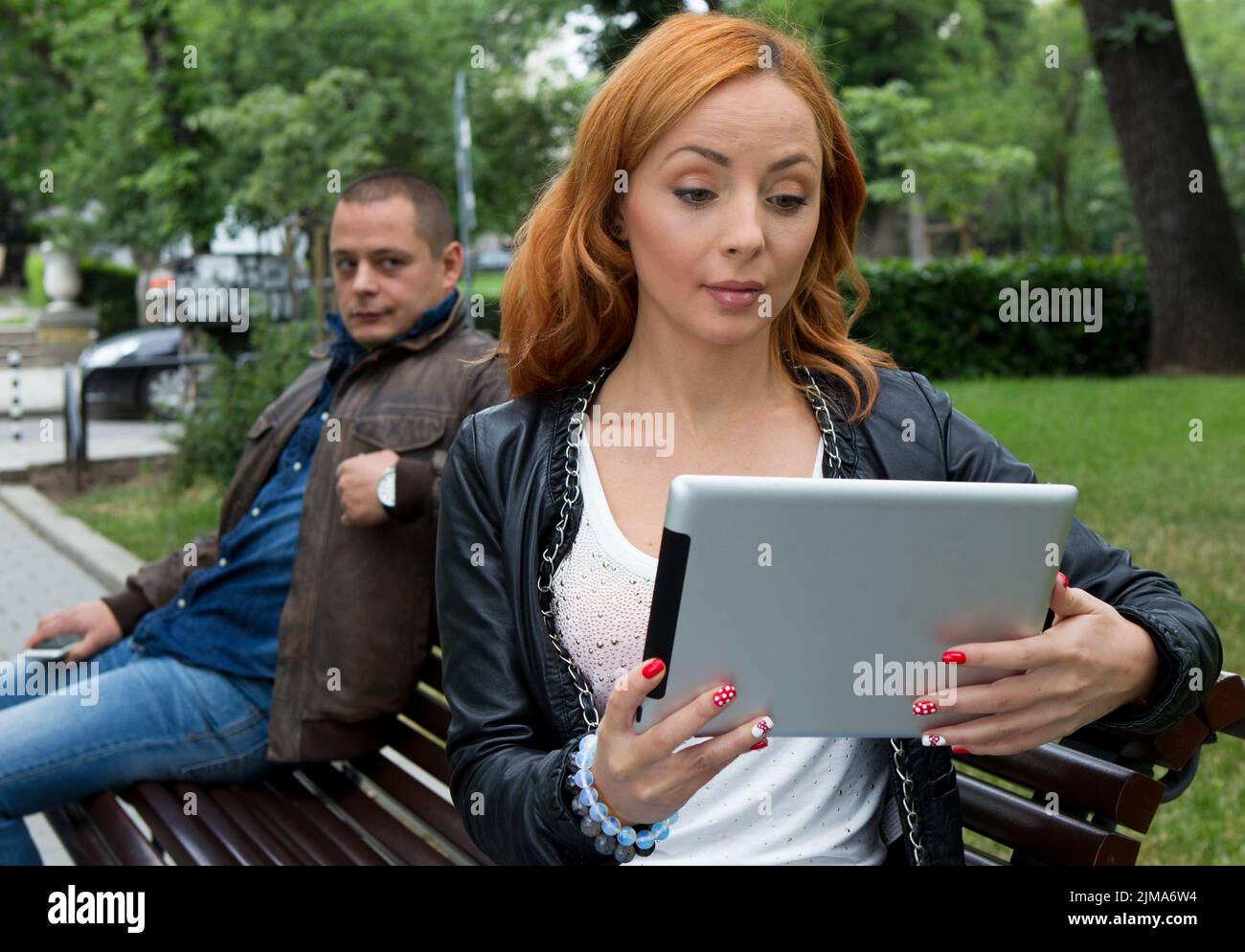 Friends are fun to watch something on a mobile phone and tablet Stock ...