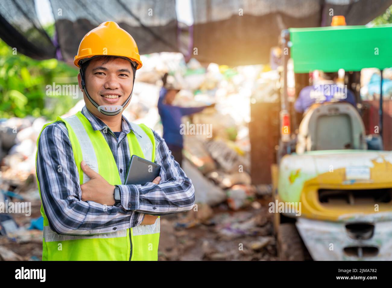 Portrait of Asian workers in recycling factory with a forklift on the ...