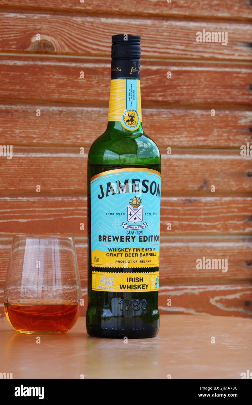 Whiskey bottle and glass with wooden background Stock Photo - Alamy