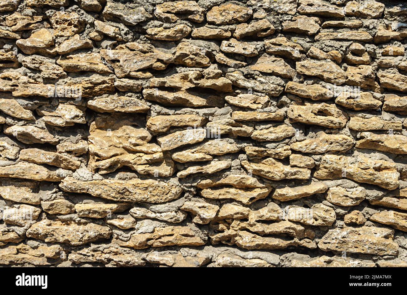 Wall of rough stones shell Stock Photo - Alamy