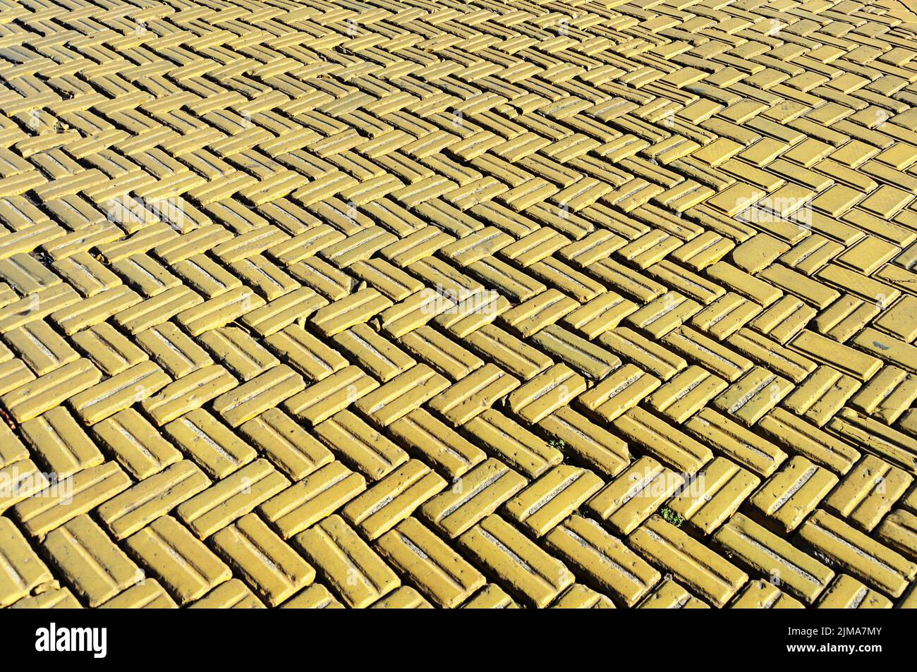 Yellow tiled road background Stock Photo - Alamy