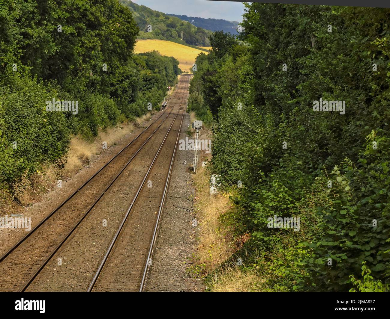 Railway tracks leading out of Dorking in Surrey, UK through fields and ...