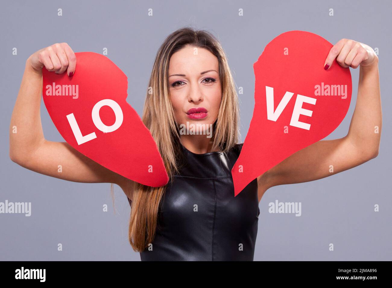 Valentines Day. Woman wearing red dress holding big heart sign love ...