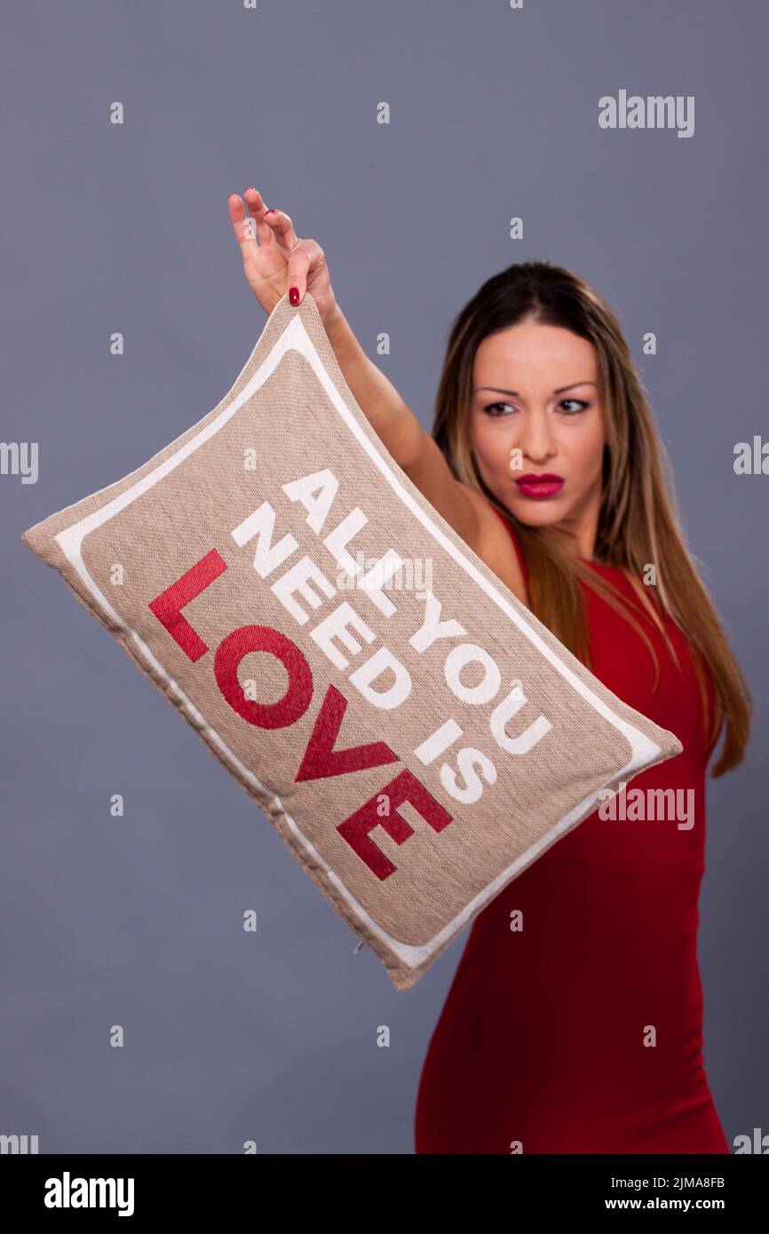 Valentines Day message with pillow all you need is love Stock Photo - Alamy