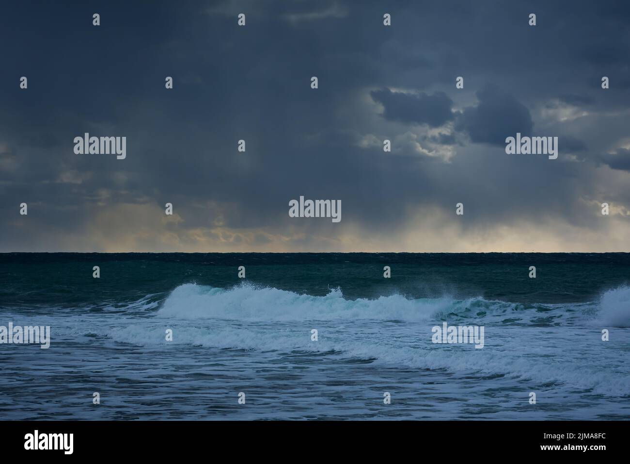 Storm clouds over the sea are black and blue. A hurricane is coming, a ...