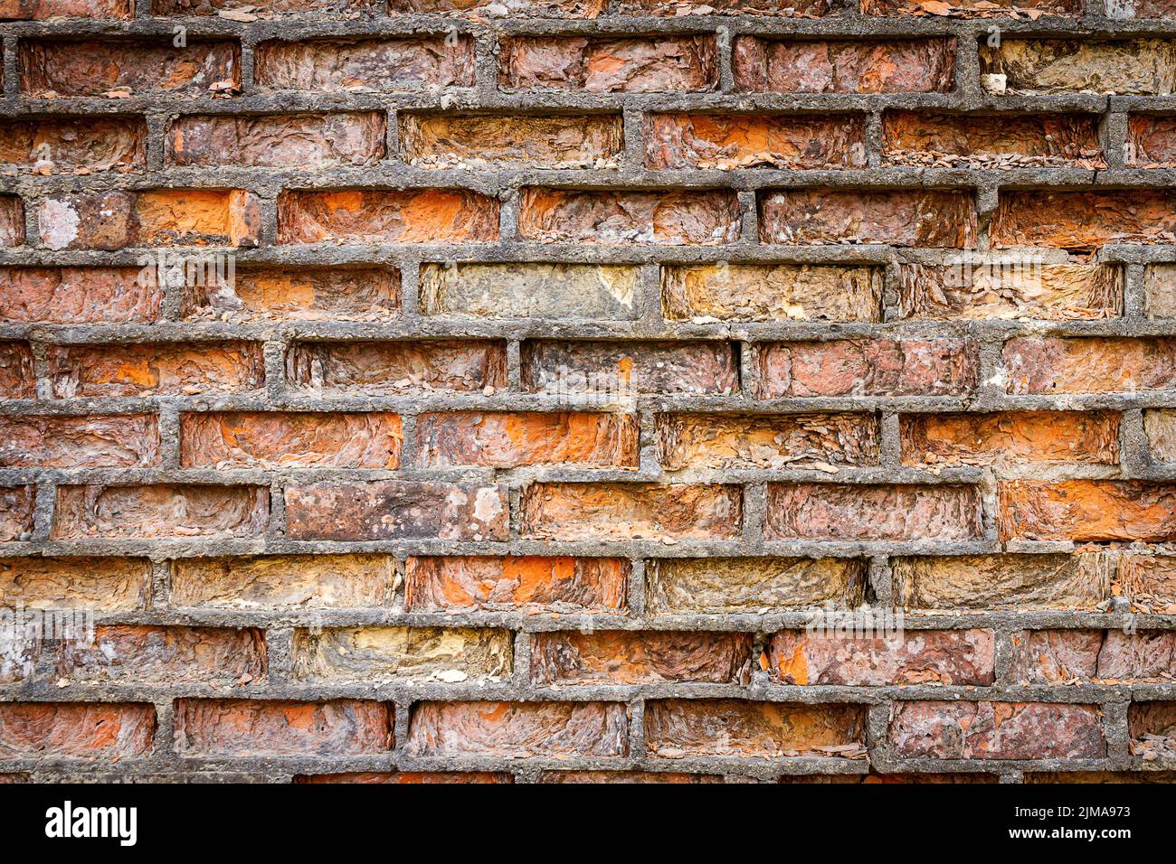 Background of yellow and red brick wall texture Stock Photo - Alamy