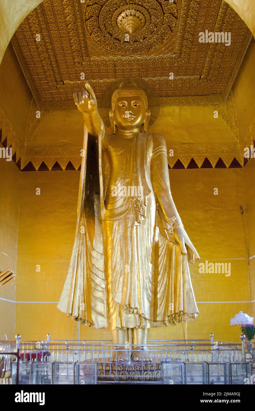 Gold sculpture of Buddha pointing Stock Photo - Alamy