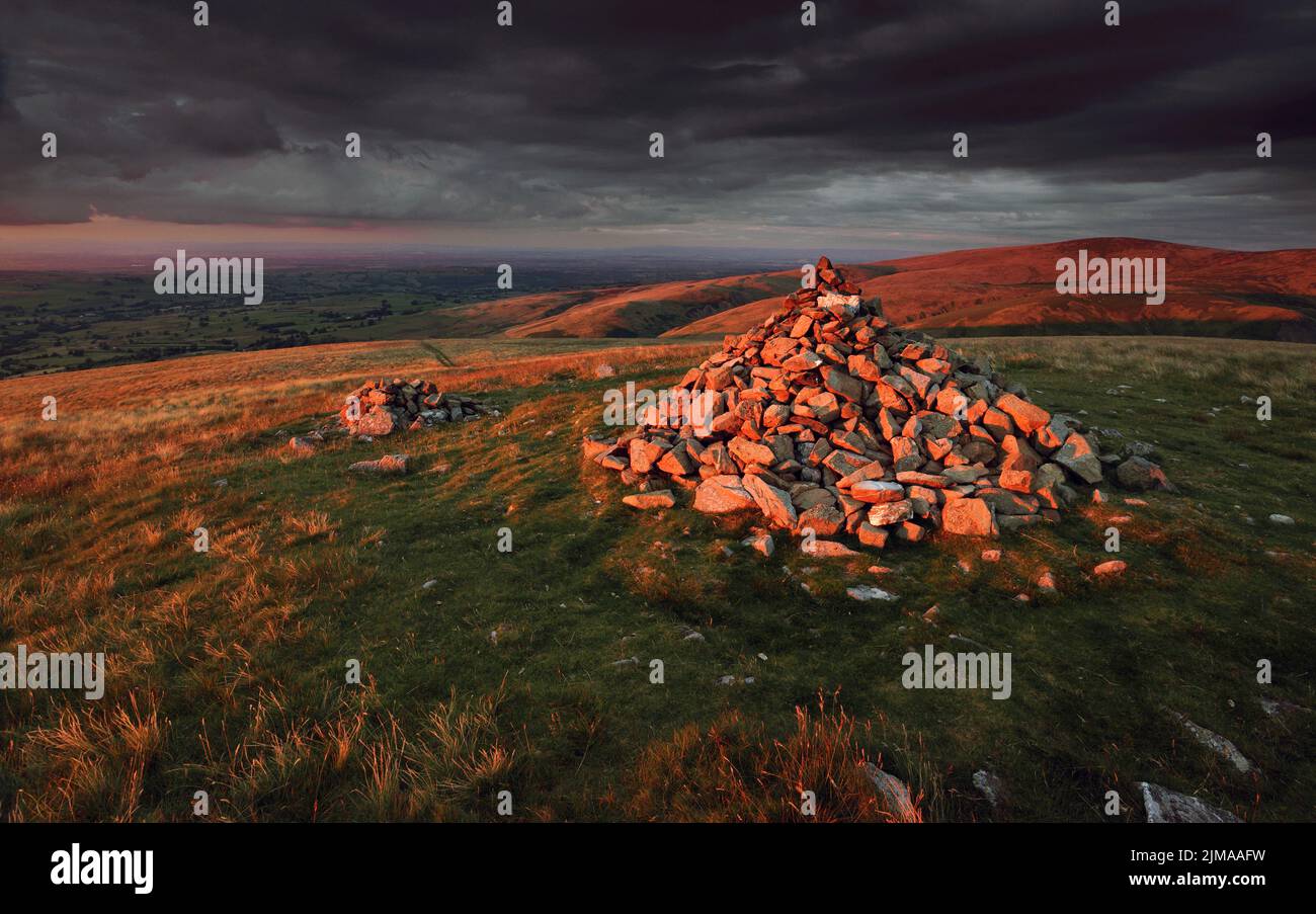 The summit cairn of Brae Fell pictured at sunset in the Lake District ...