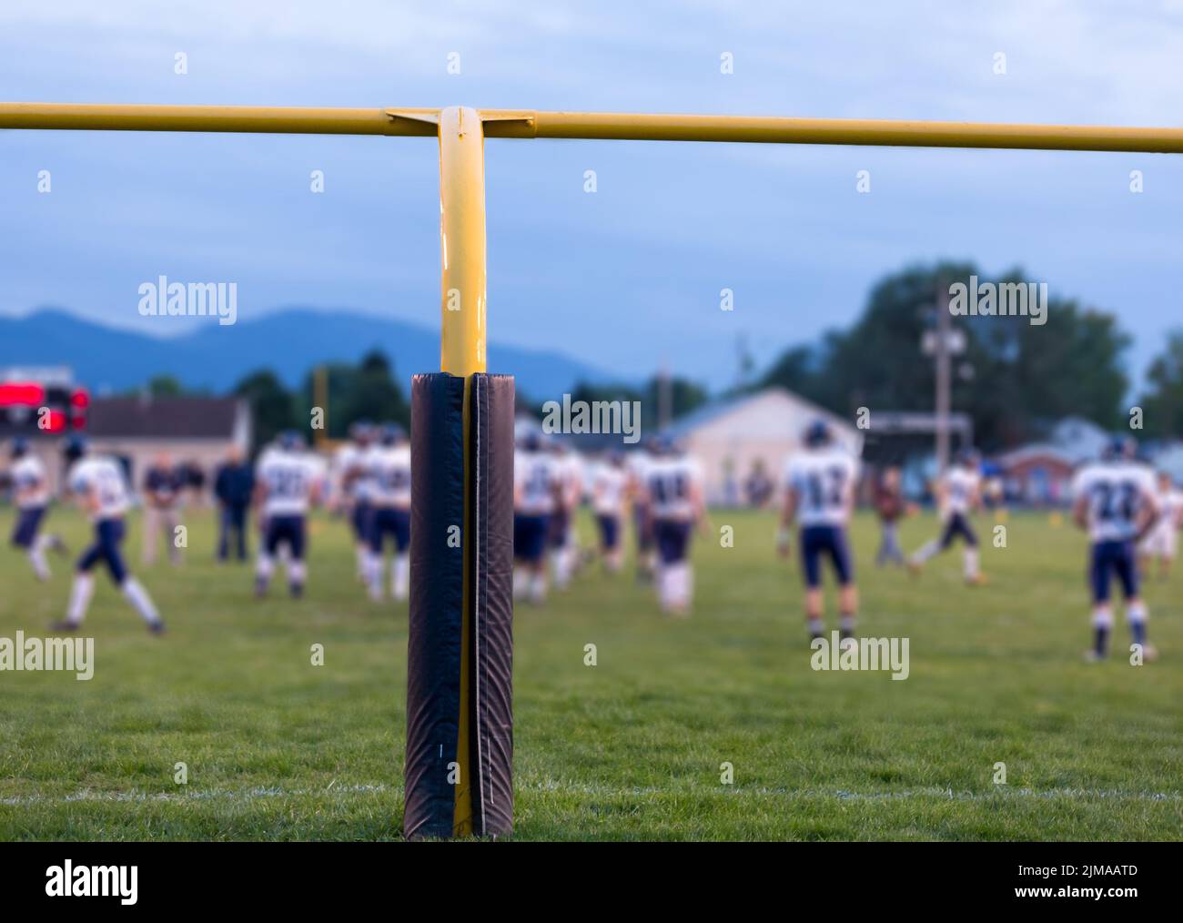 American football goal posts with blurred team Stock Photo - Alamy