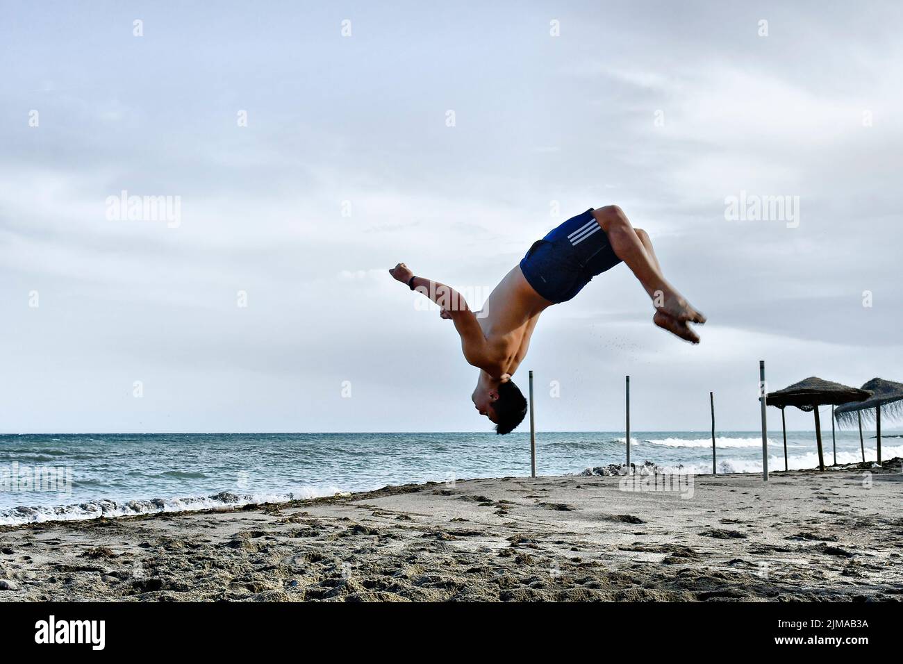Young man doing backflips somersaults in the sand Stock Photo - Alamy Young man doing backflips somersaults in the sand Stock Photo - Alamy