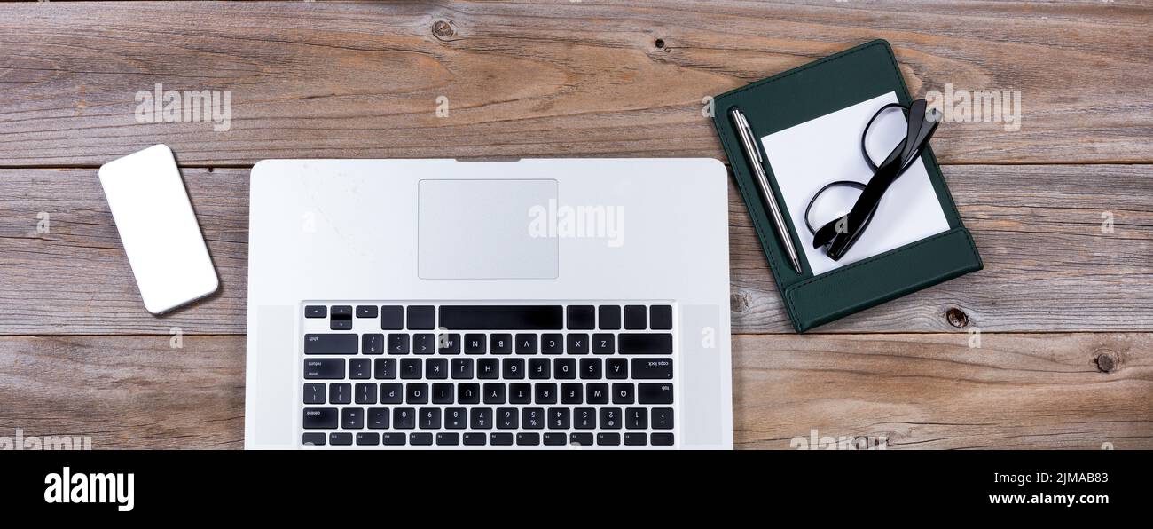 Top view of working desktop with mobile devise and traditional paper ...