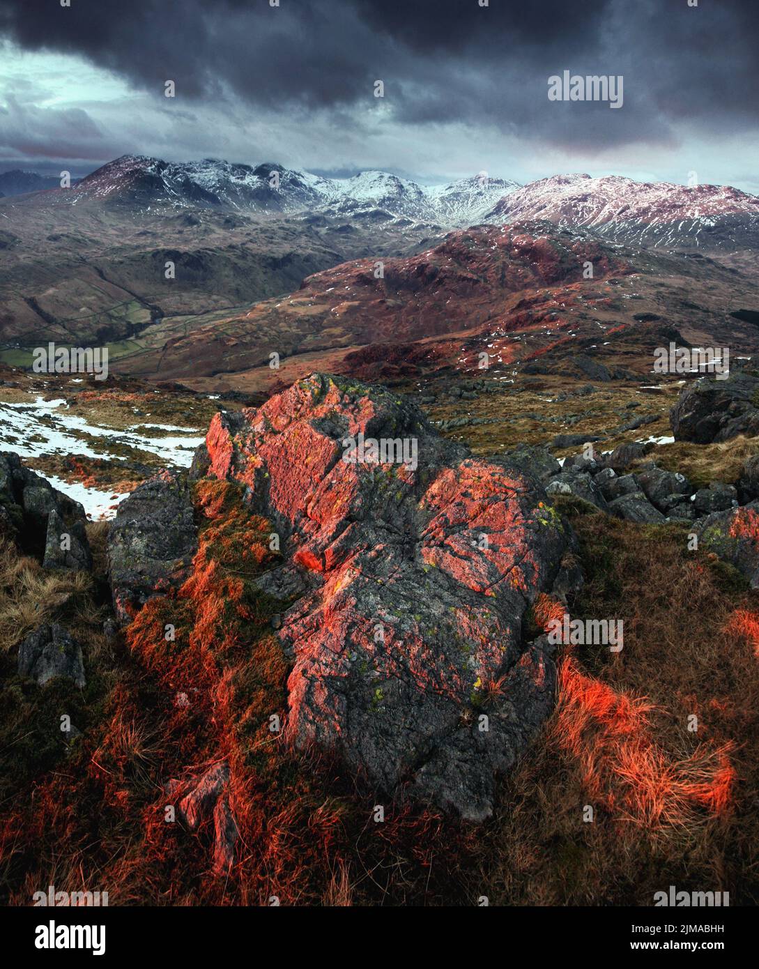 A moody sunset view from Harter Fell towards Scafell Pike in the Lake ...
