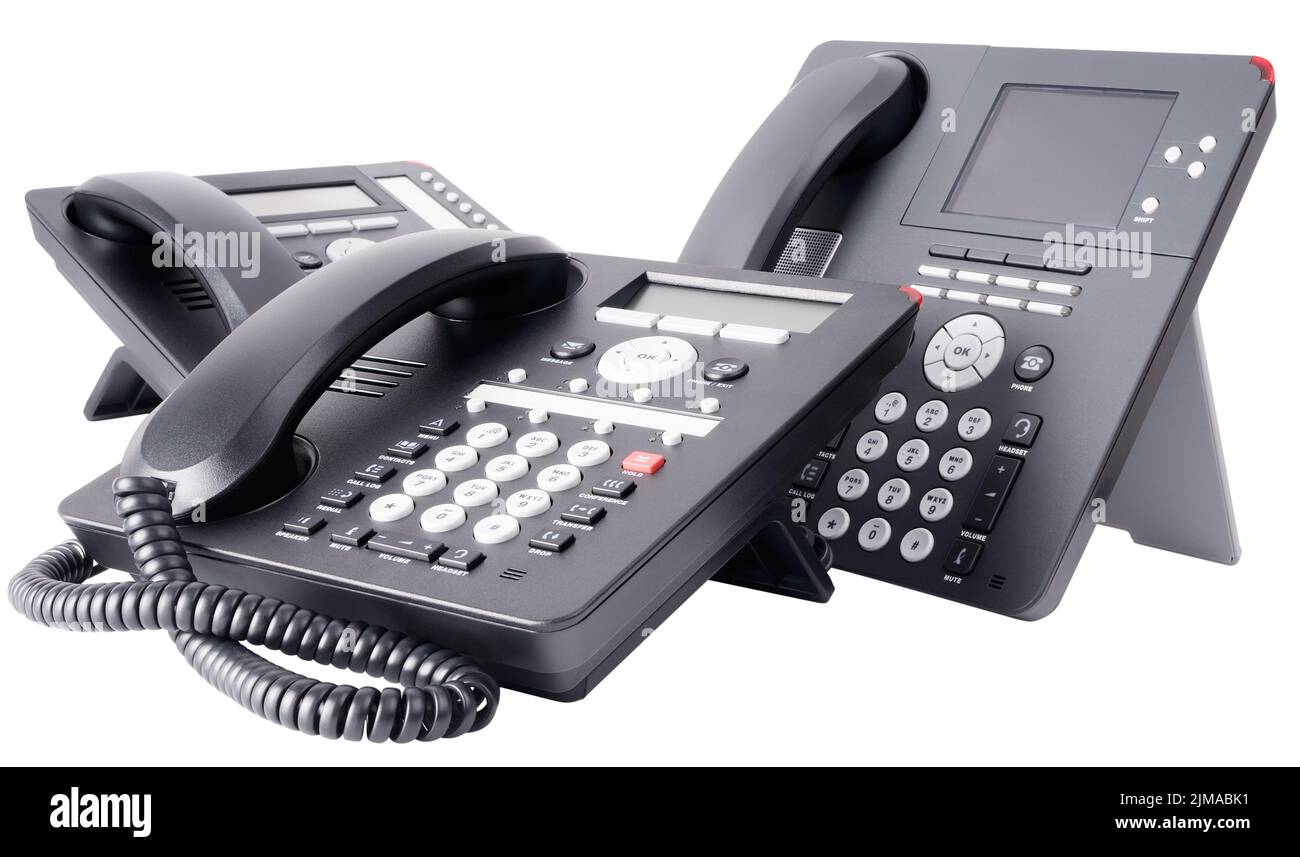 Three office digital telephone sets with LCD isolated on the white ...