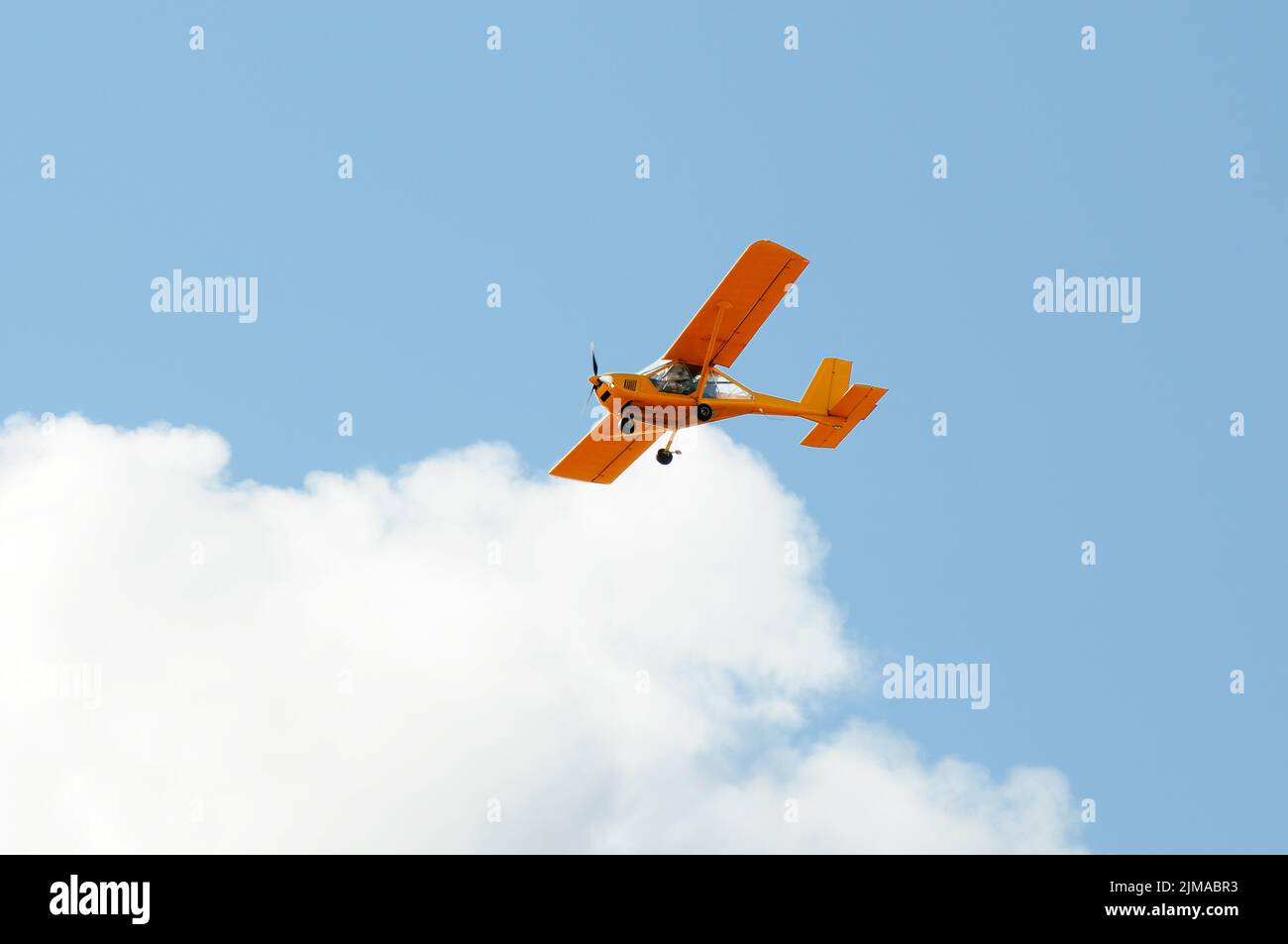 Flying private propeller-driven airplane over blue sky Stock Photo - Alamy