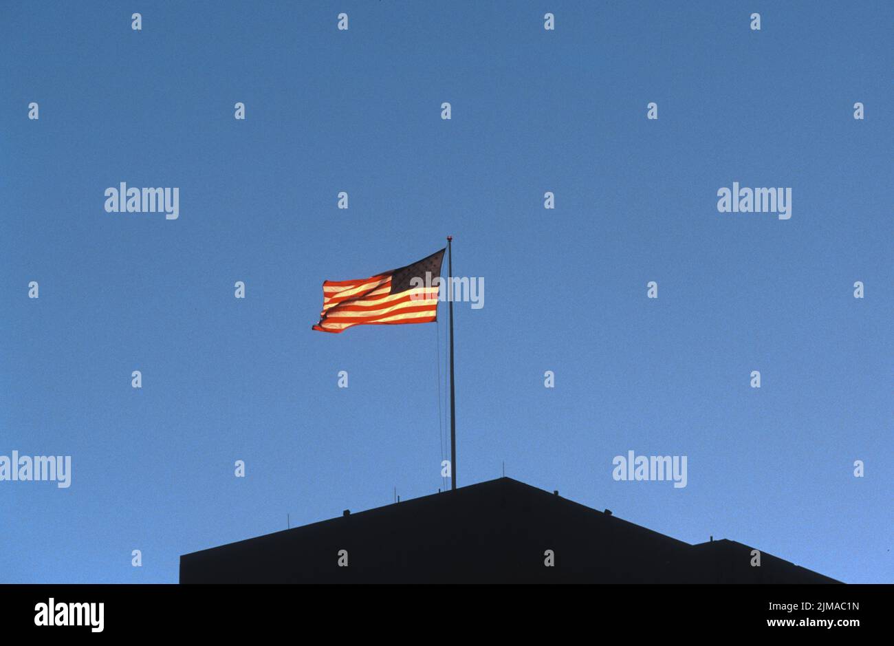 American flag flies atop a building in downtown San Diego, California ...