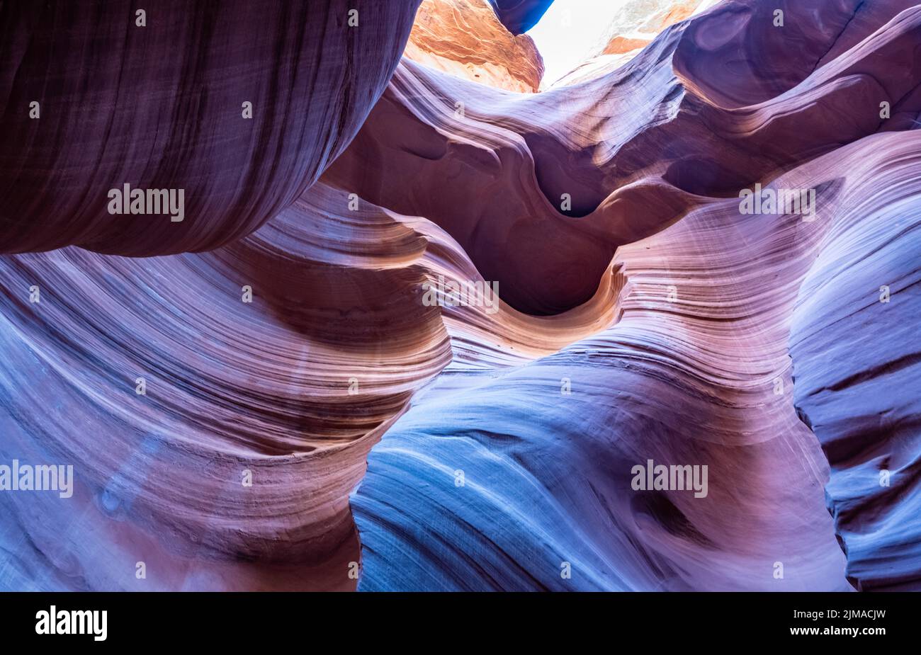 Wavy structures and walls in Antelope Canyon glow yellow, red and blue ...
