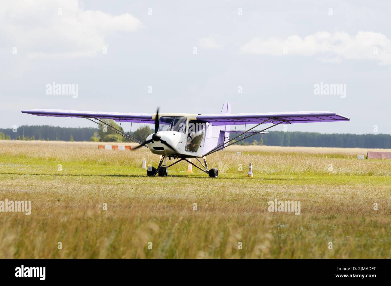 Private propeller-driven airplane standing on green grass Stock Photo ...