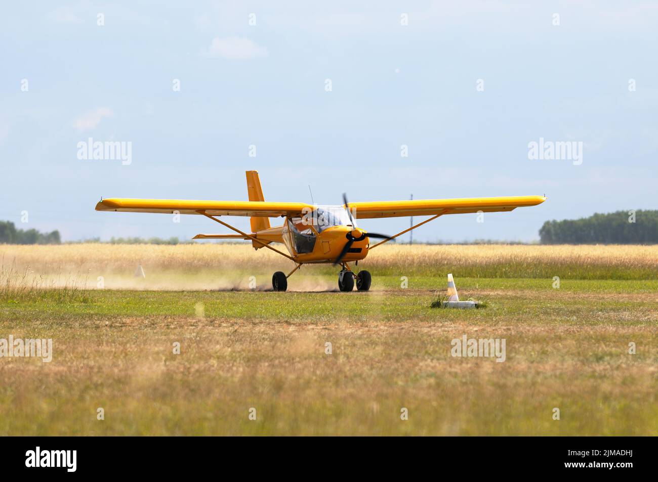 Private propeller-driven airplane landing on green grass Stock Photo ...