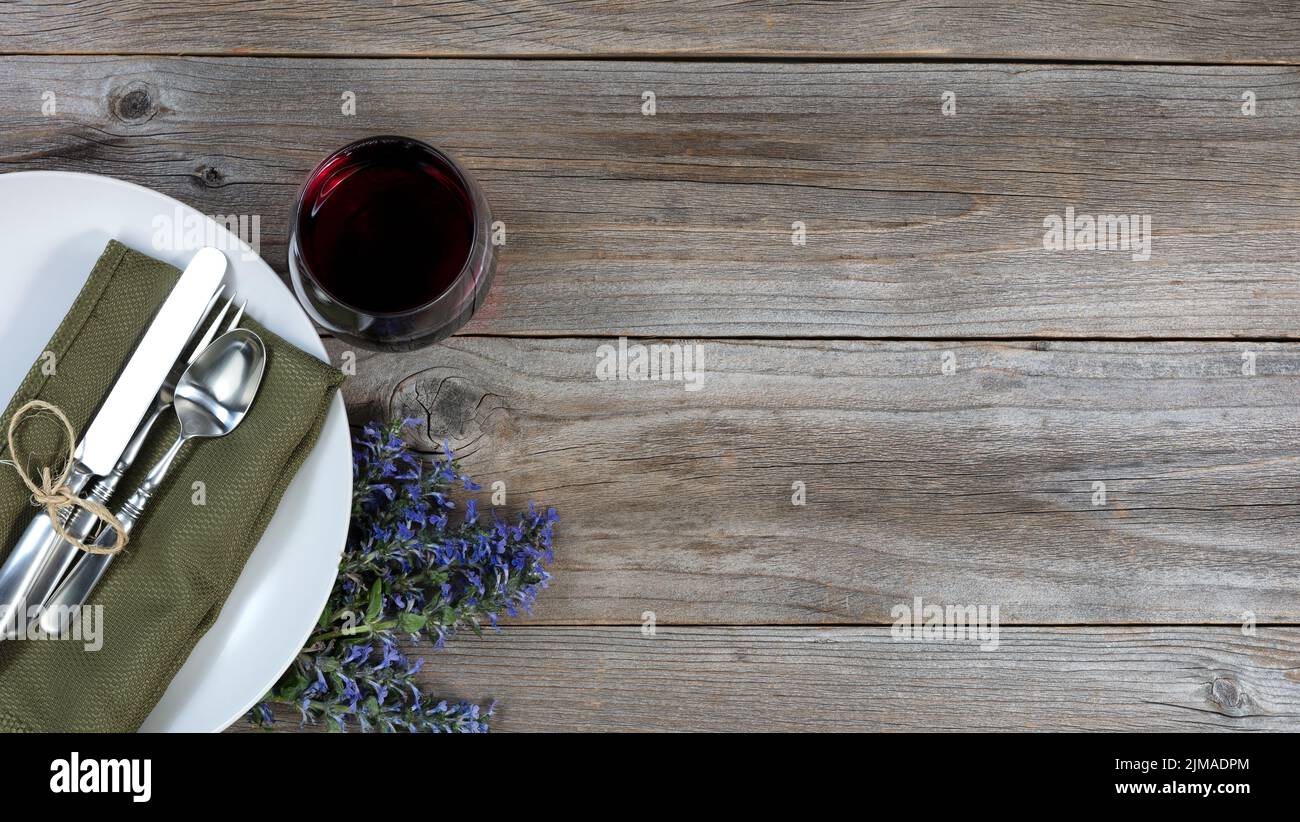 Vintage Dinnerware On Rustic Wooden Table With Flowers And A Glass Of