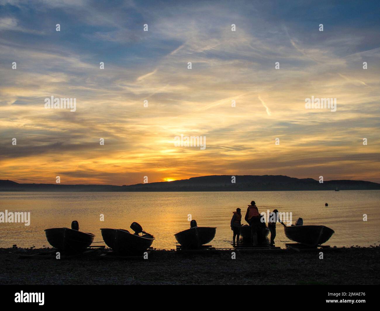 Rowing boats at sunset hi-res stock photography and images - Alamy