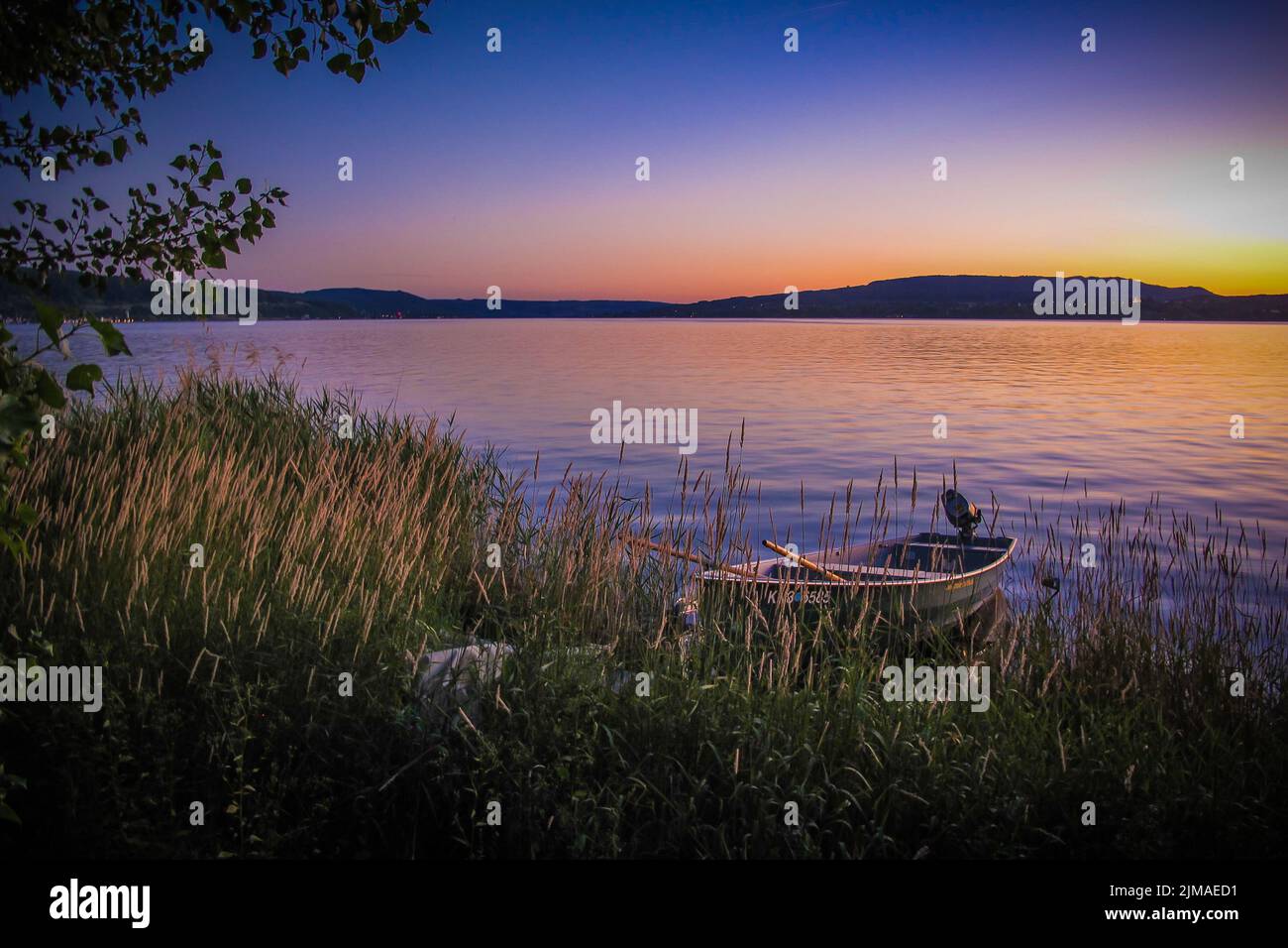 Boat at sunset on the island of Reichenau - lake constance Stock Photo ...