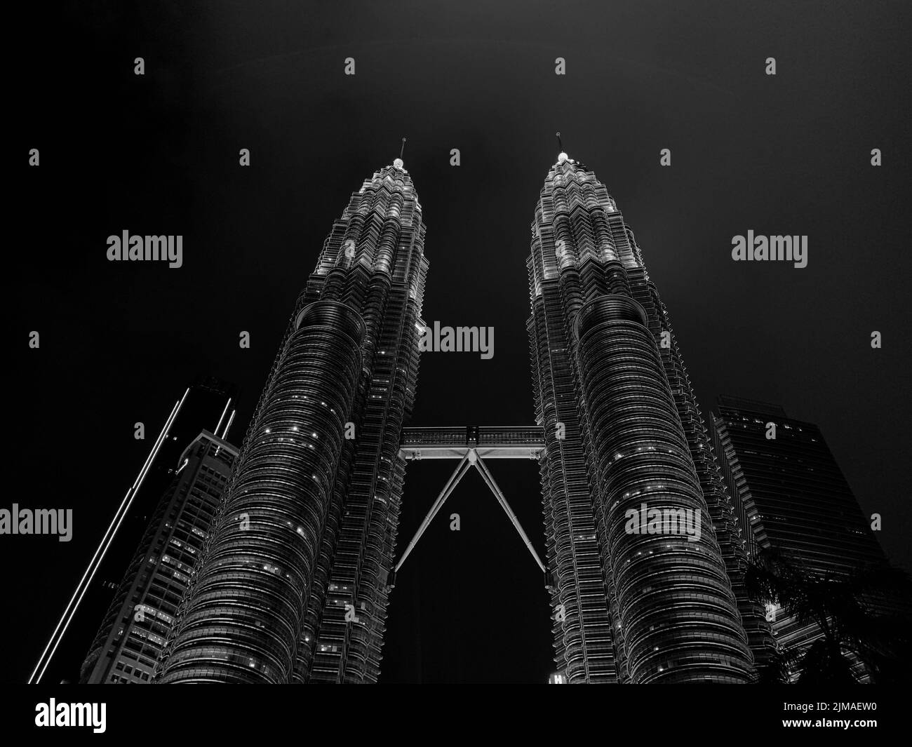 The low-angle view of the Petronas twin tower at night in Kuala Lumpur ...